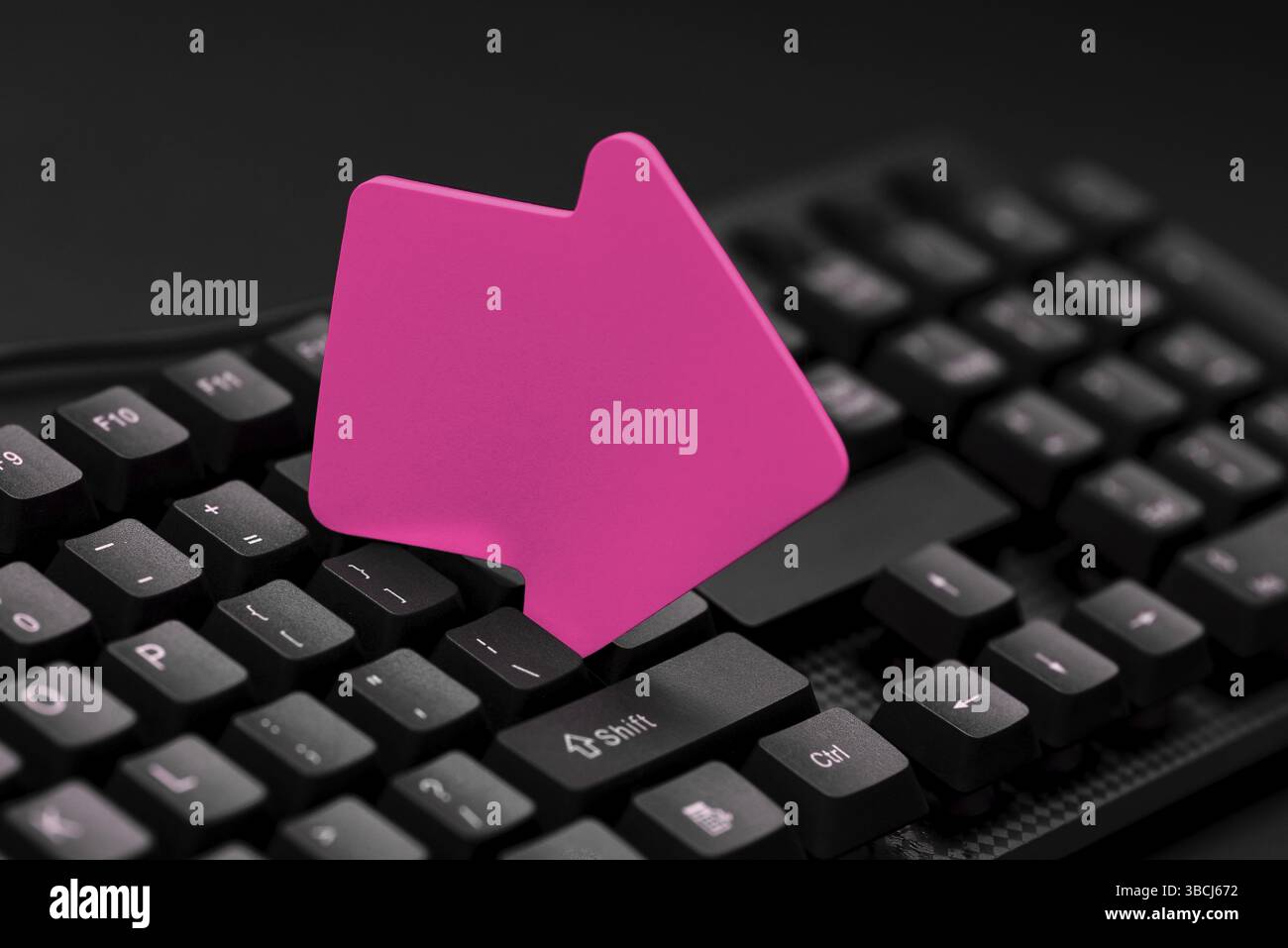 Colored sticker lying on keyboard. Important message written over paper ...