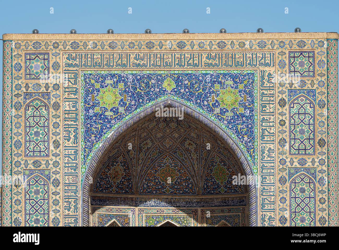 The ornate entrance of Tilya Kori Madrasa in Samarkand's Registan is ...