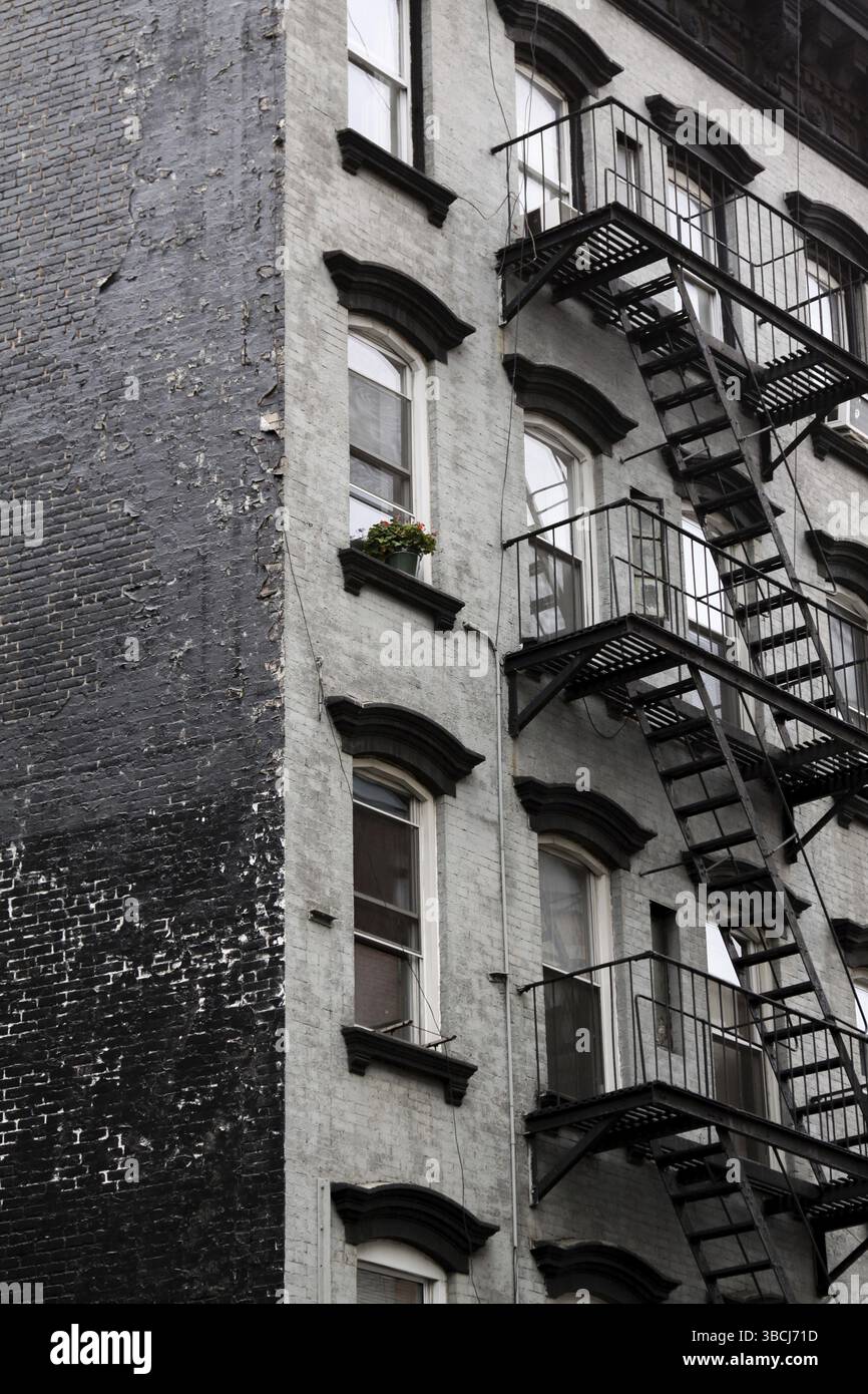 Fire escape from high-rise building in New York, dark backyard in black ...