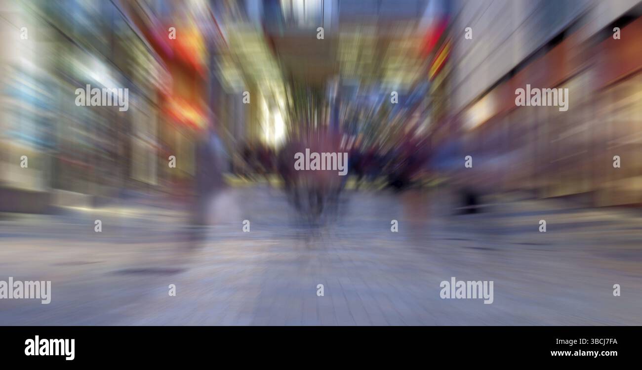 Abstract zoom blur of a modern city street at night with people walking ...