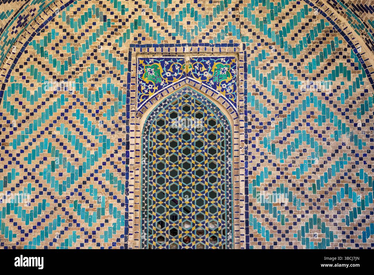 Intricate mosaic patterns in yellow, blue and orange decorate a wall at ...