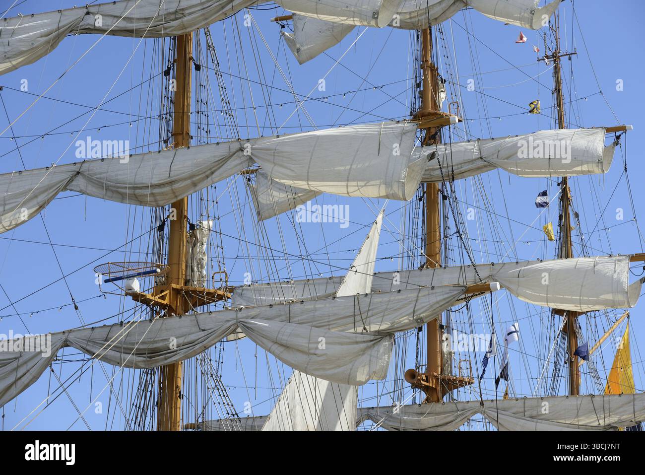 A detailed close-up view of the intricate rigging, masts, and sails of ...