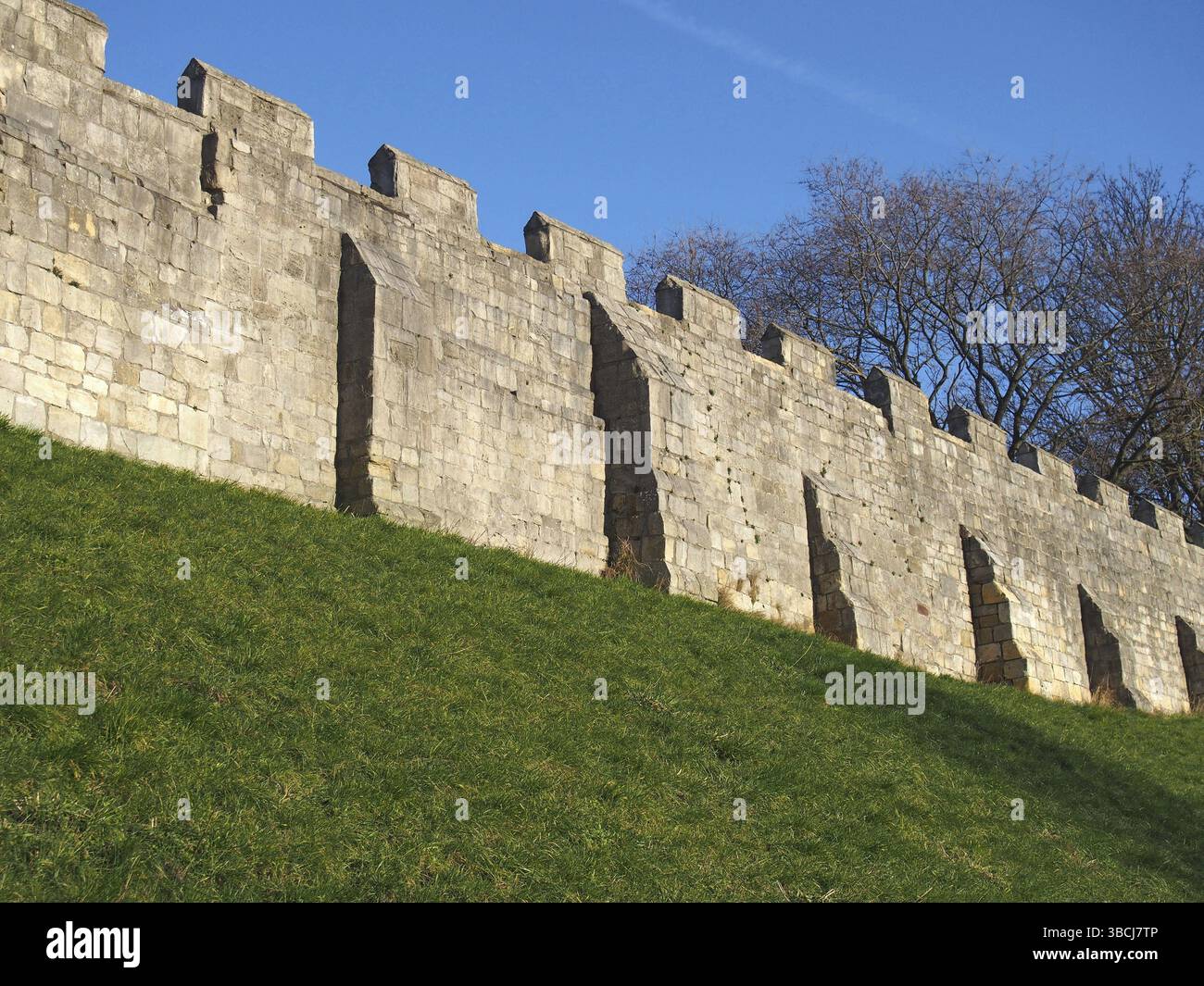 A view of the ancient medieval city walls of york with grass covered ...