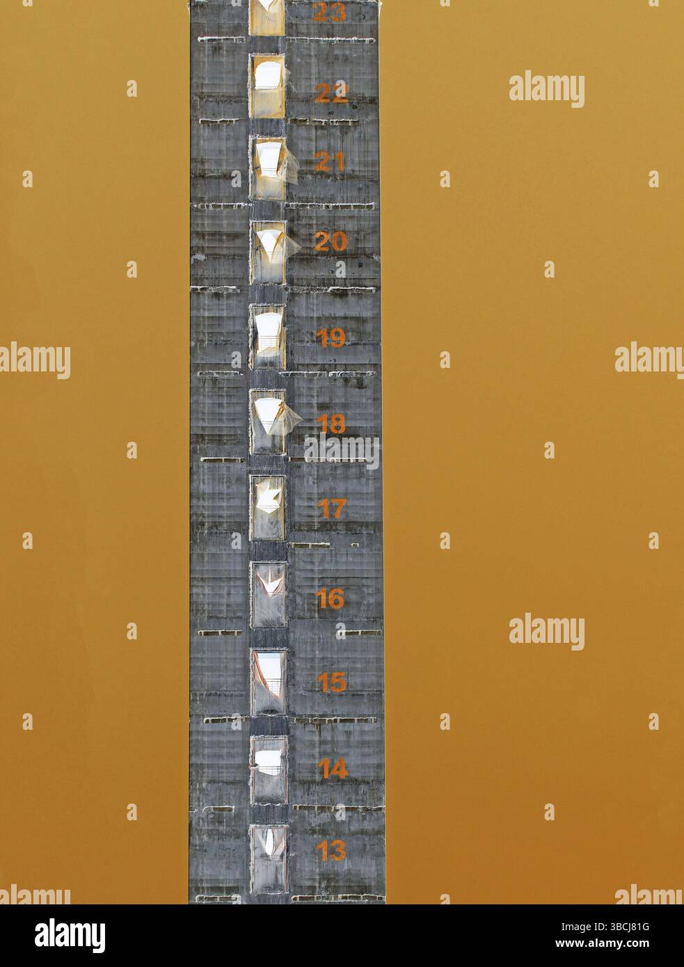 Color negative image of a tall concrete tower under construction with ...