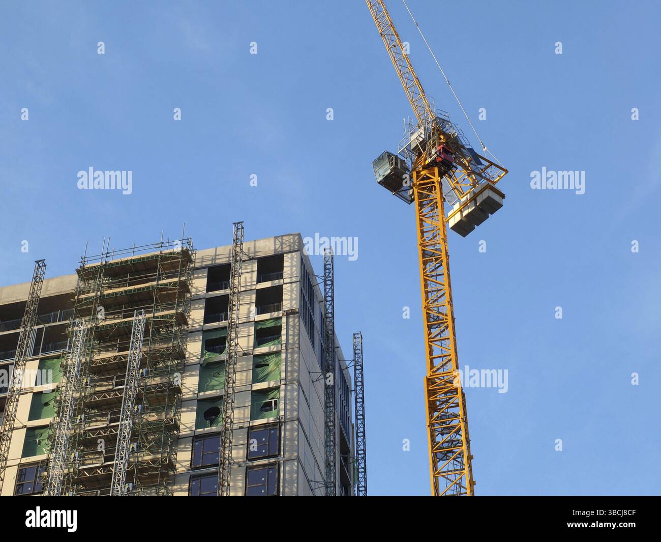 A large modern building under construction covered in scaffolding with ...