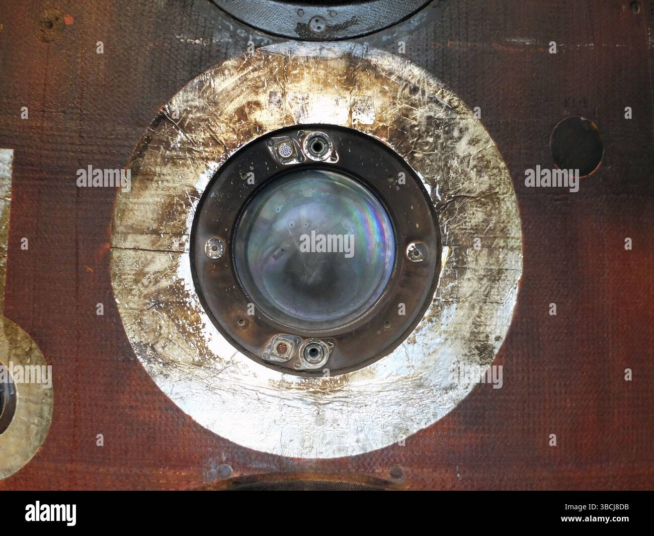 A close up of a round porthole on a used russian space re-entry vehicle ...