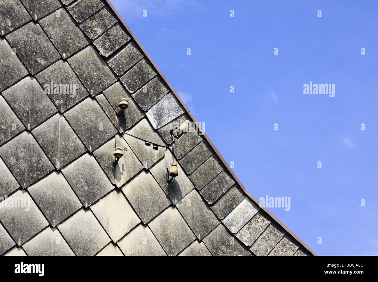 Insulators on Eternit facade, detail, background blue sky Stock Photo ...