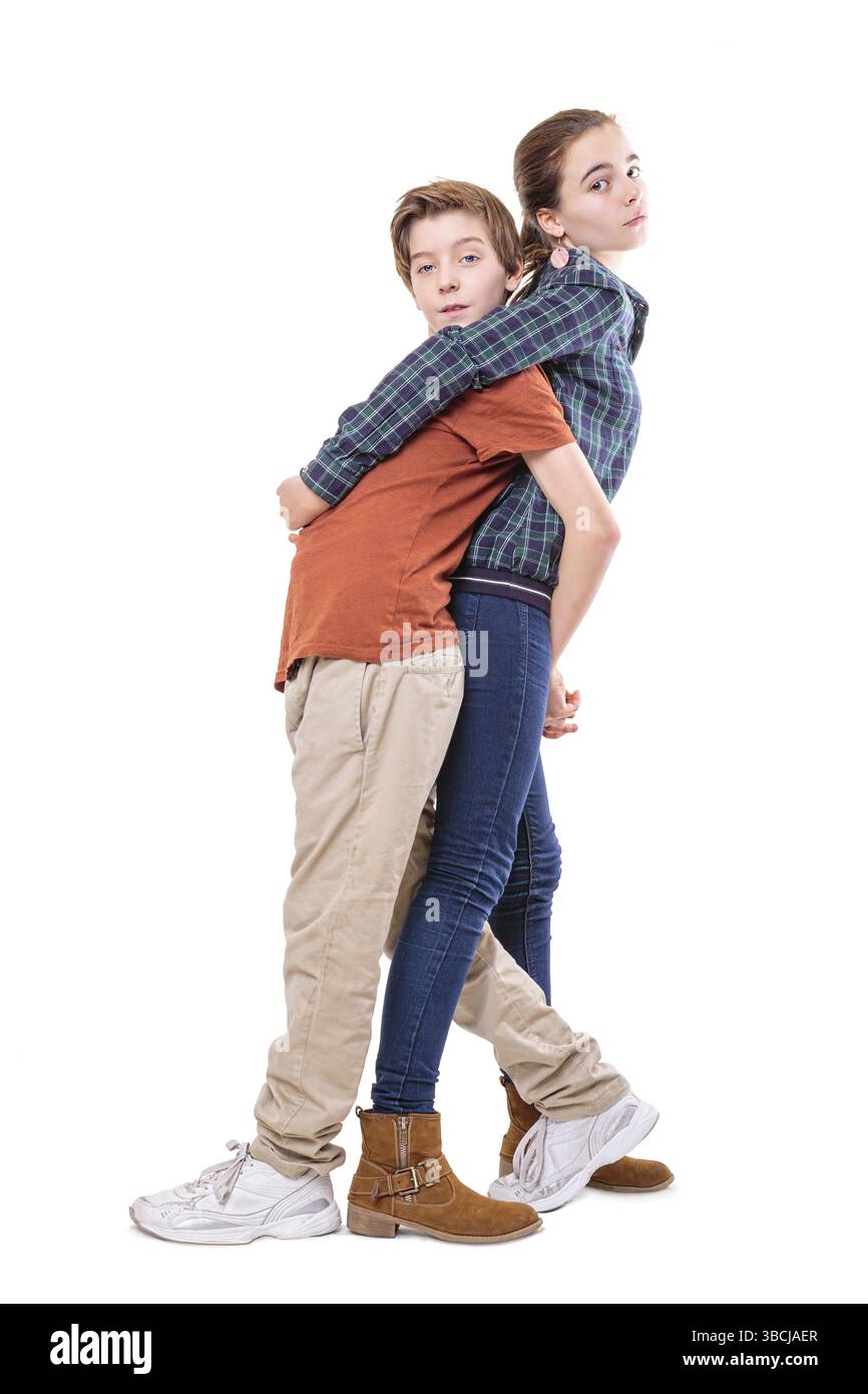 Teenager siblings hugging back on back, isolated on white Stock Photo ...