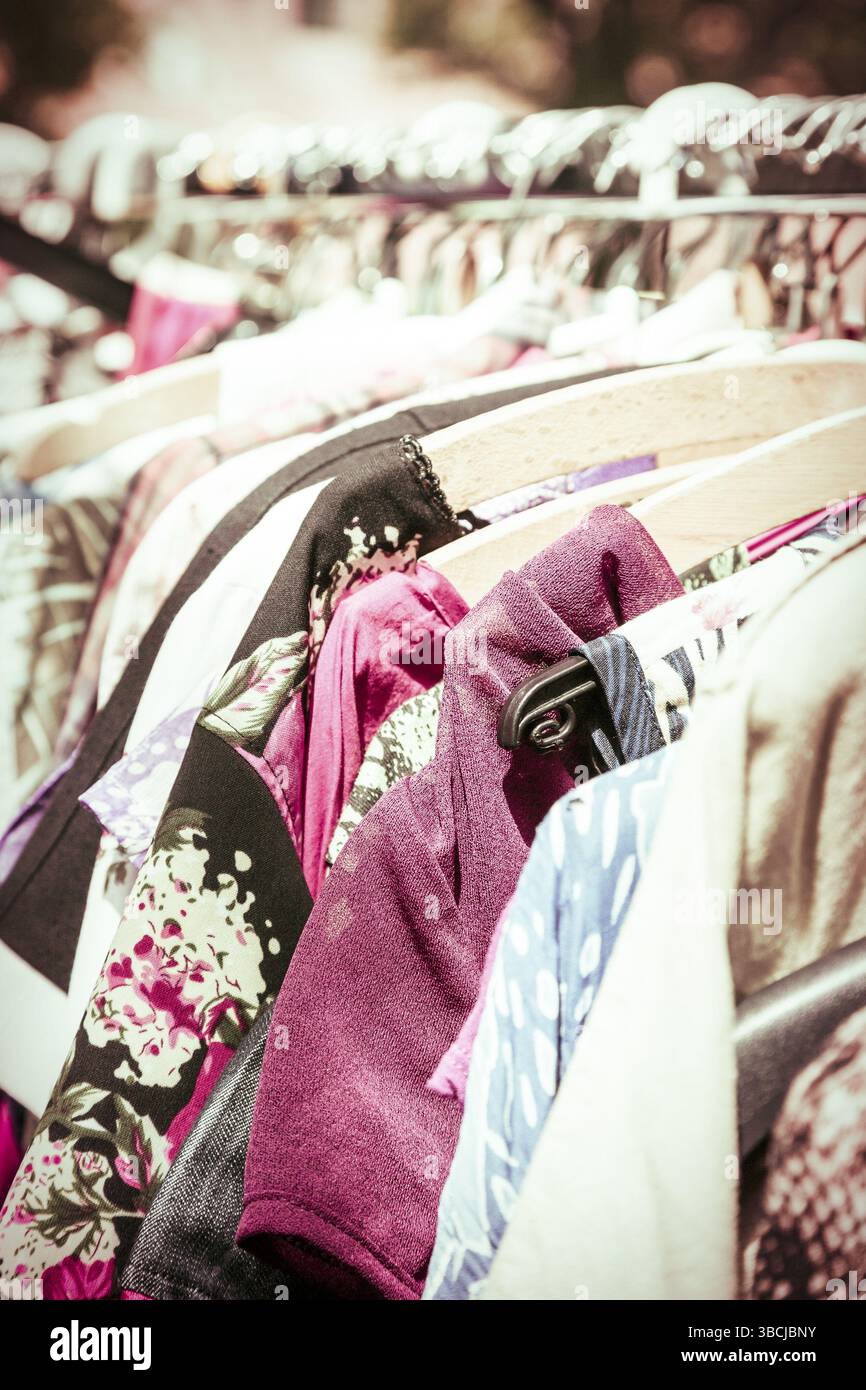 Clothes on a rack on a flea market Stock Photo - Alamy