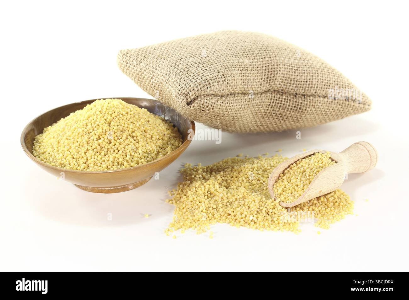 Fresh dried millet in a bowl with a bushel and bag Stock Photo - Alamy
