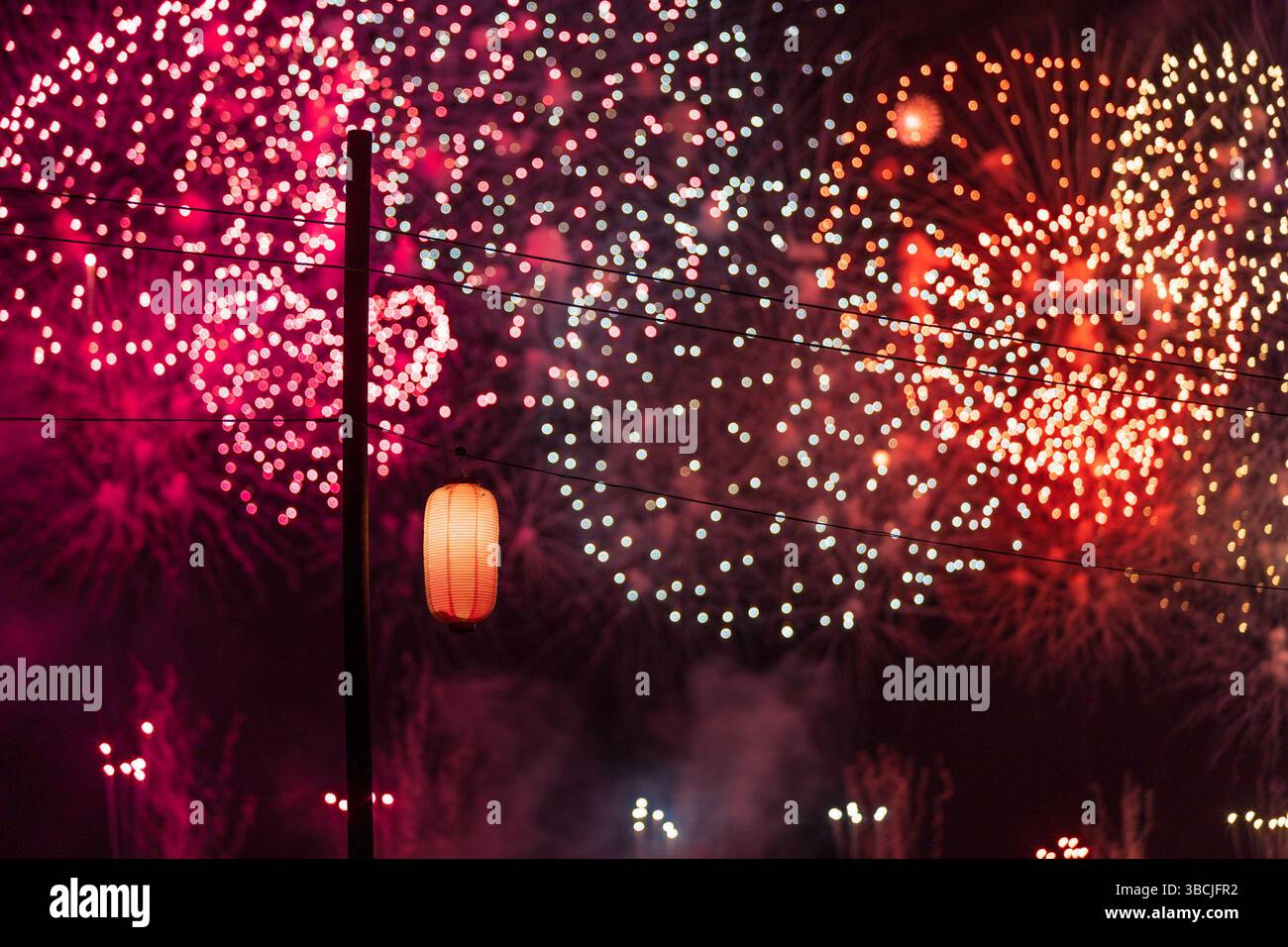 Fireworks Display Over a Night Sky with a Japanese Lantern Stock Photo ...