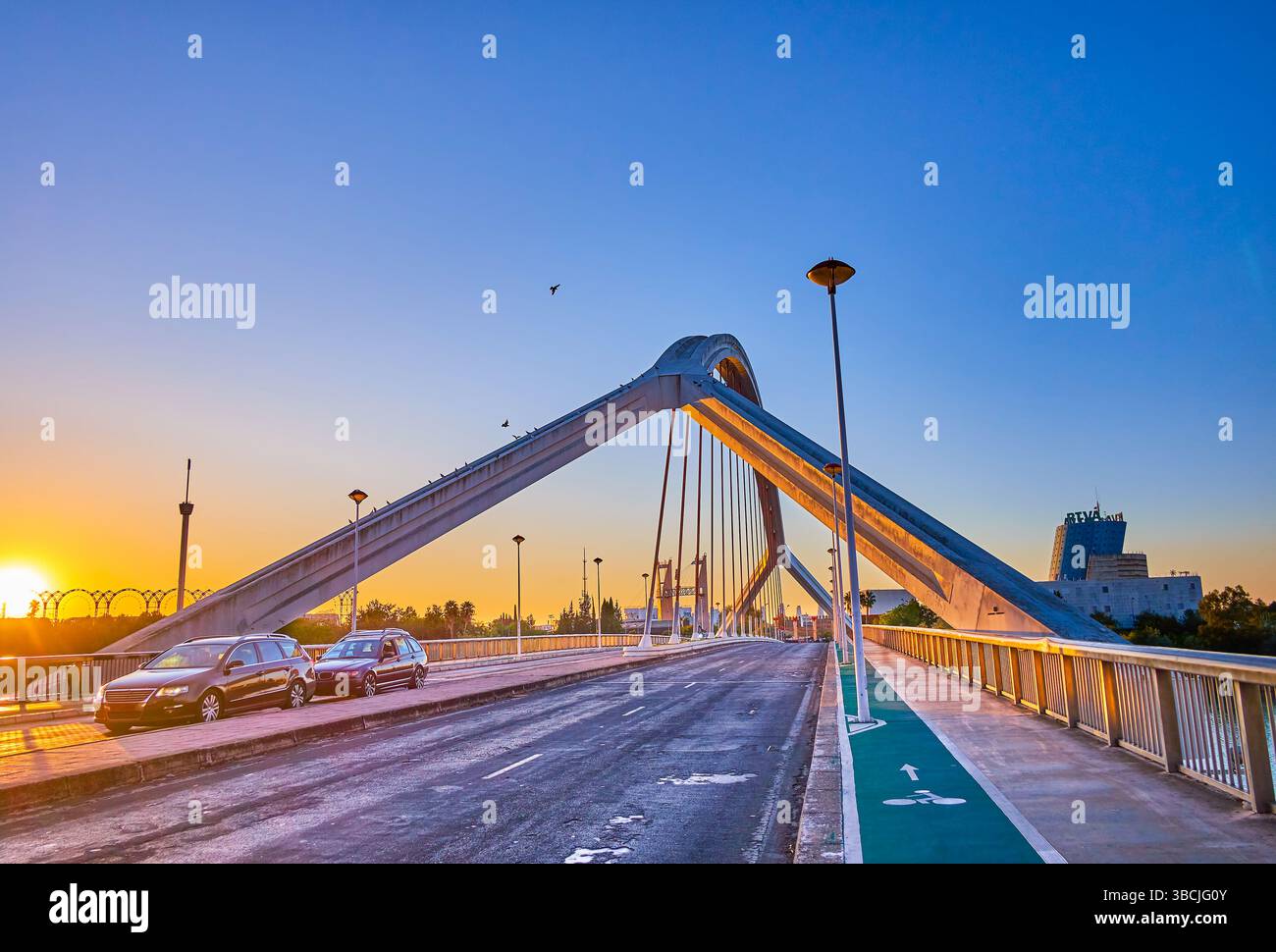 The modern Barqueta bridge across Guadalquivir river with unique arch ...