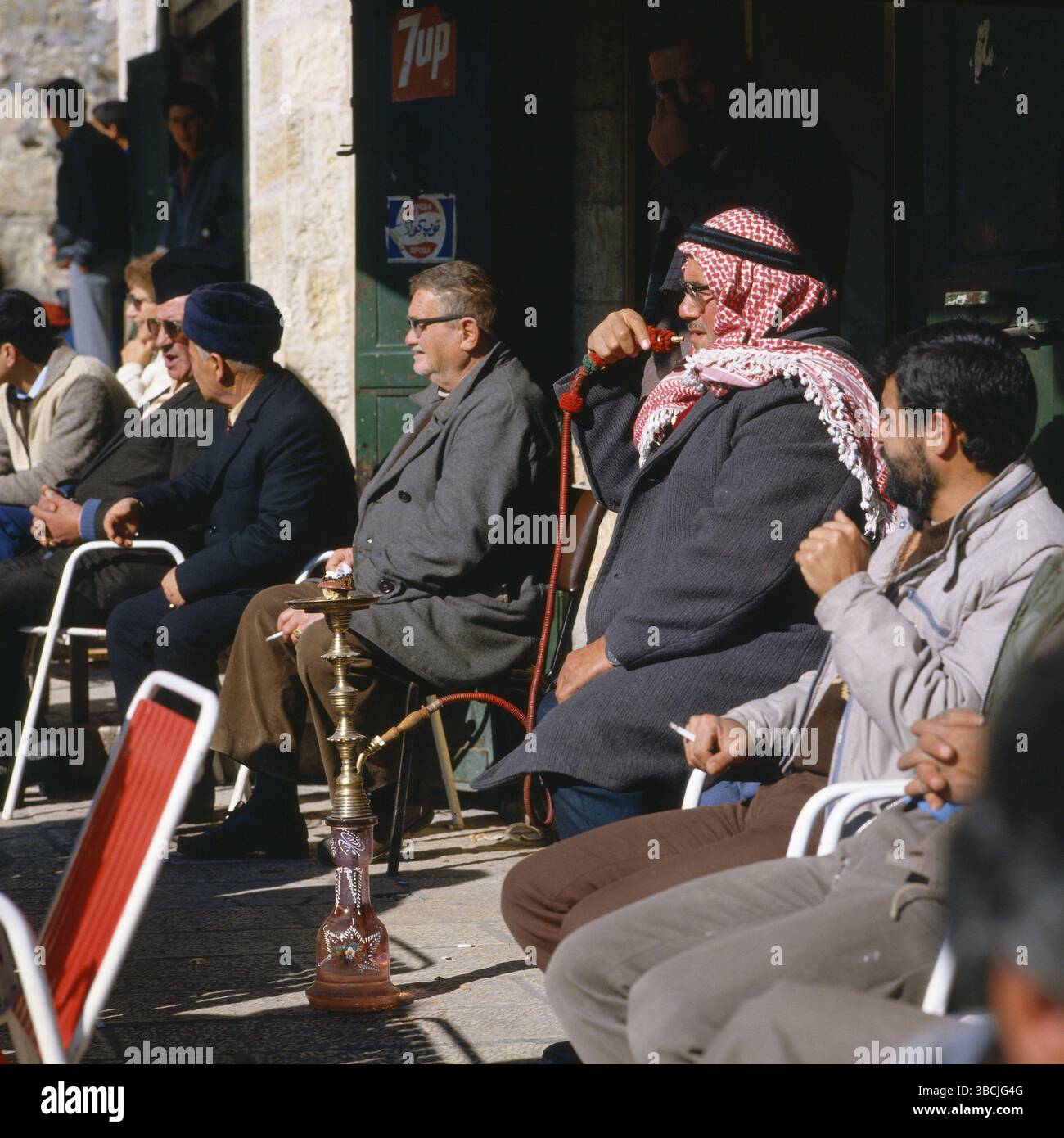 Man smoking waterpipe in a pavement cafe, man smoking waterpipe eem ...