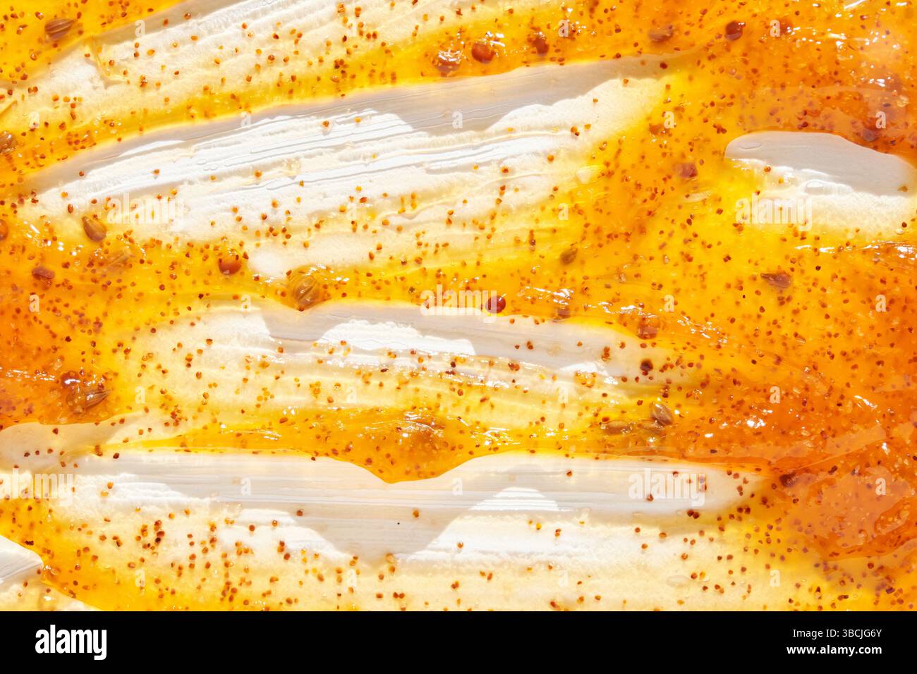 Bright orange jam spread with creamy strokes and seed textures Stock ...