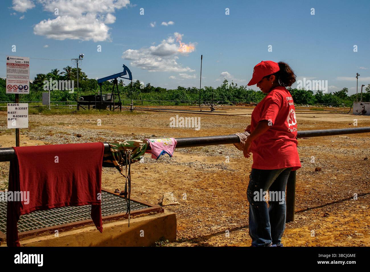 Cabimas, Zulia, Venezuela. 29-11-2025.A Venezuelan woman hangs her ...