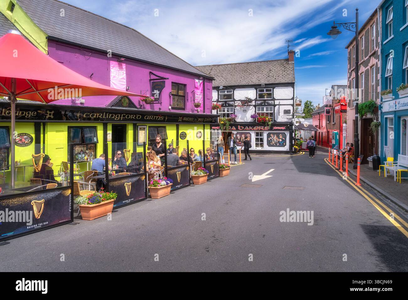 Carlingford, Ireland, 04 July 2021 A charming village street is adorned ...