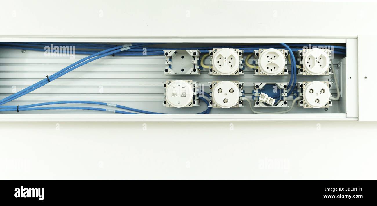 horizontal view of large unfinished electrical panel with sockets for ...