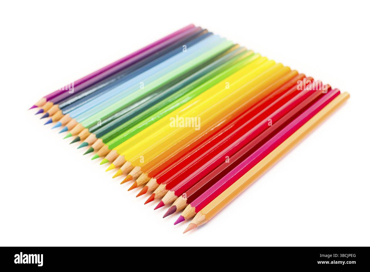 Various colored crayons lying side by side in a square isolated on ...