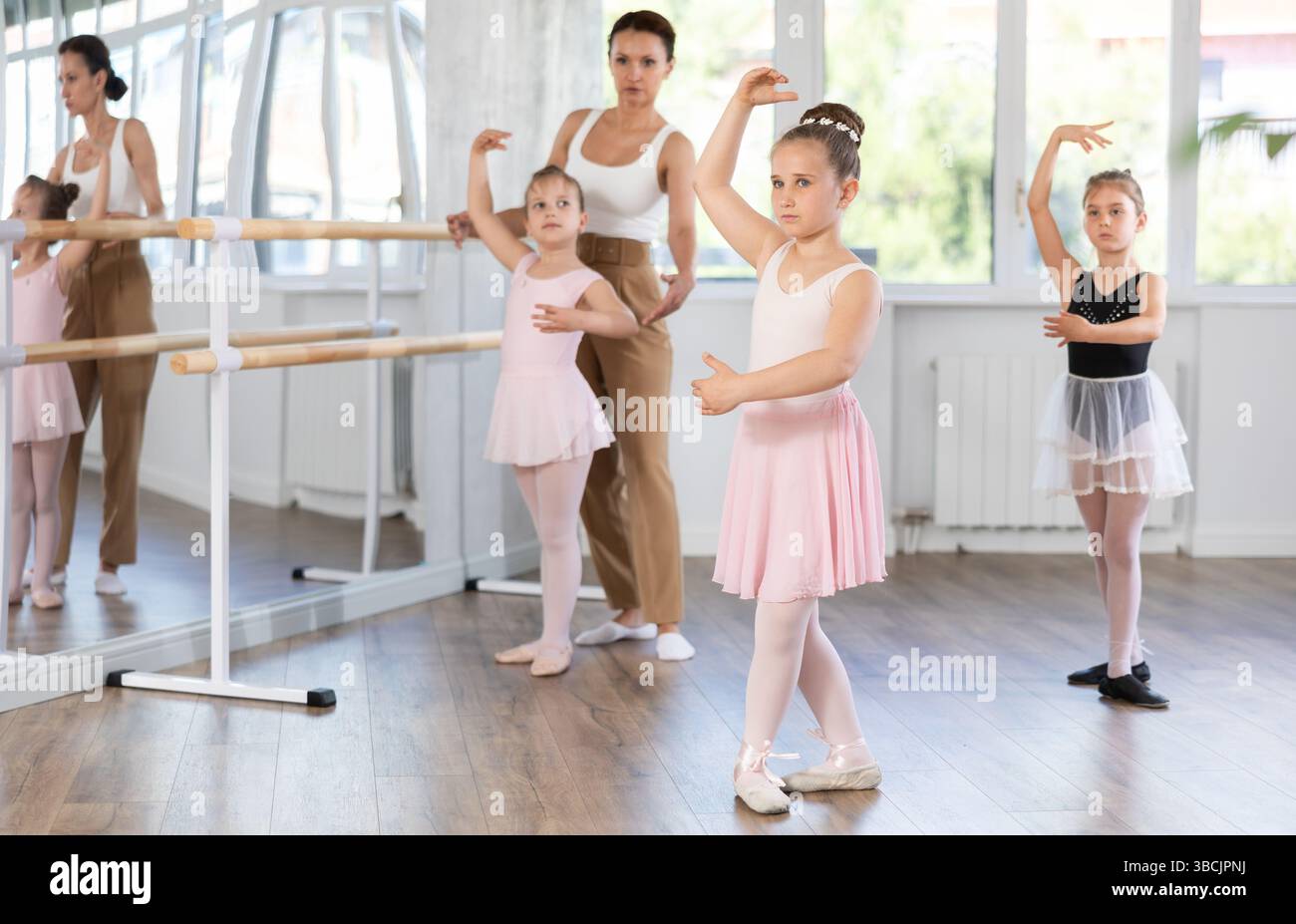 Group of girls stand in fifth position Stock Photo - Alamy