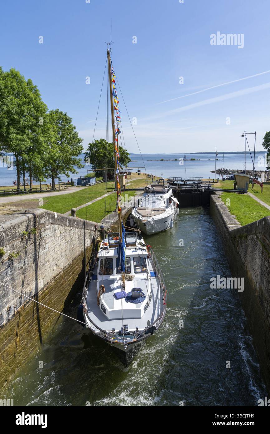 Berg, Sweden - 21 June, 2021: boats travelling upriver in the locks and ...