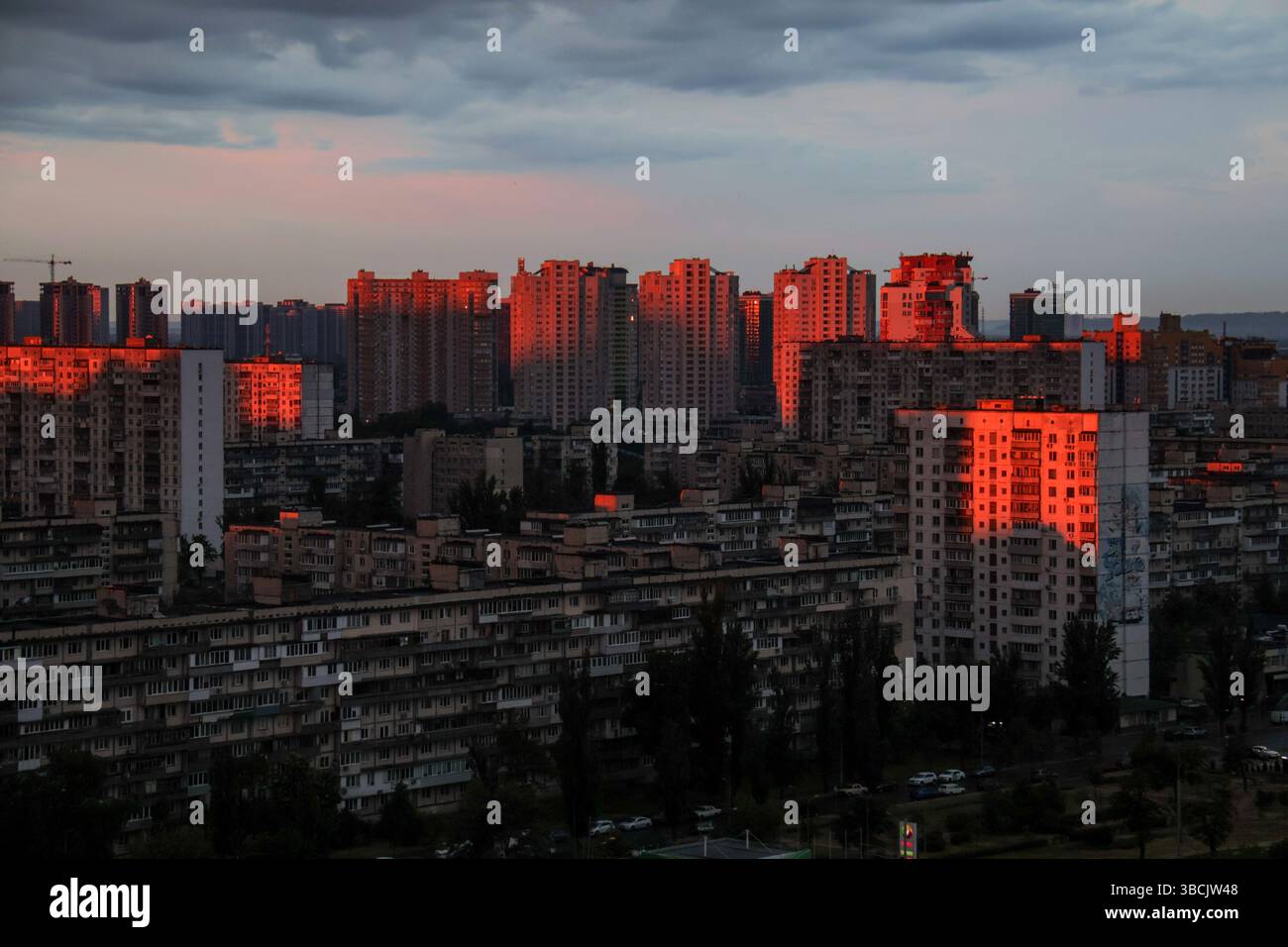 The rising sun casts red light on high-rise residential buildings, Kyiv ...