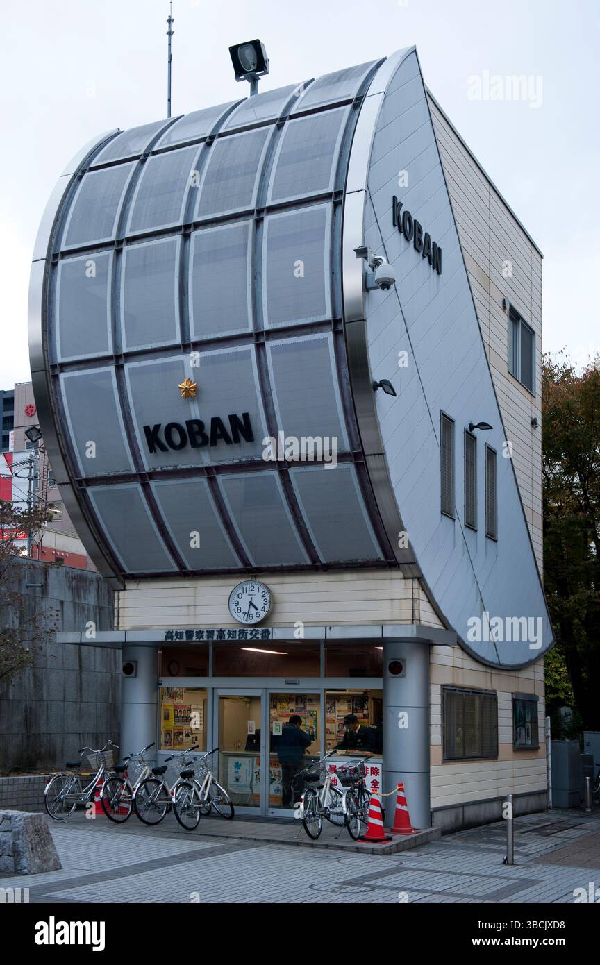 Pedestrian stops by a "koban" police box to inquire. Unique architectural designed koban are ...