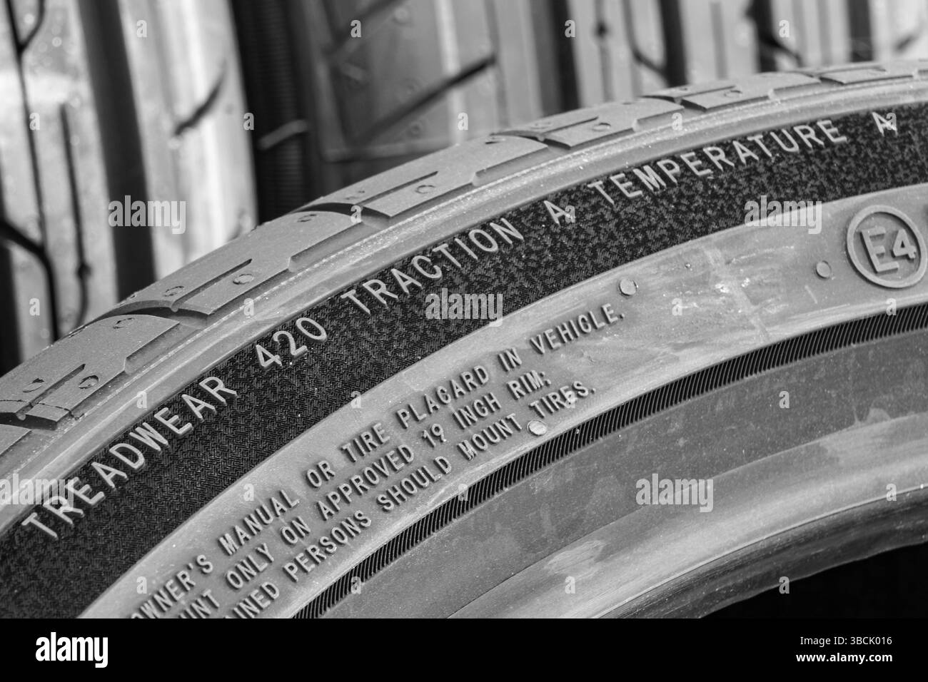 Close-Up of a Car Tire Showing Treadwear Rating, Traction Grade, and ...