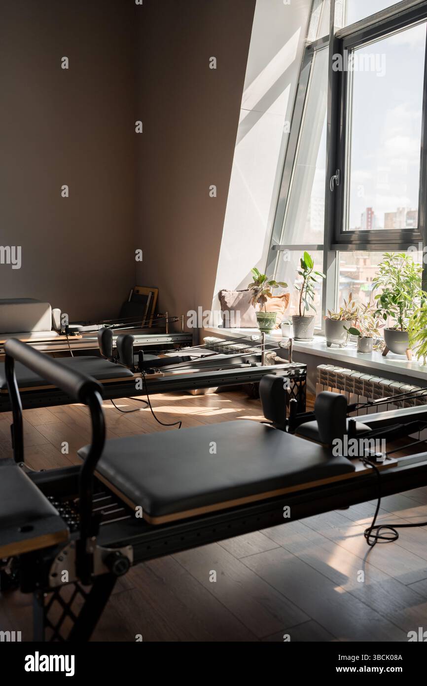 Modern Pilates studio with reformer beds bright, spacious windows for ...