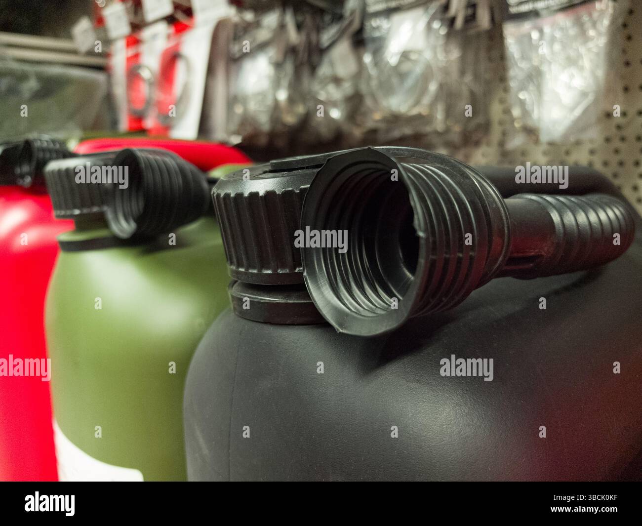 Canisters in various colors are displayed neatly on the shelf of a ...