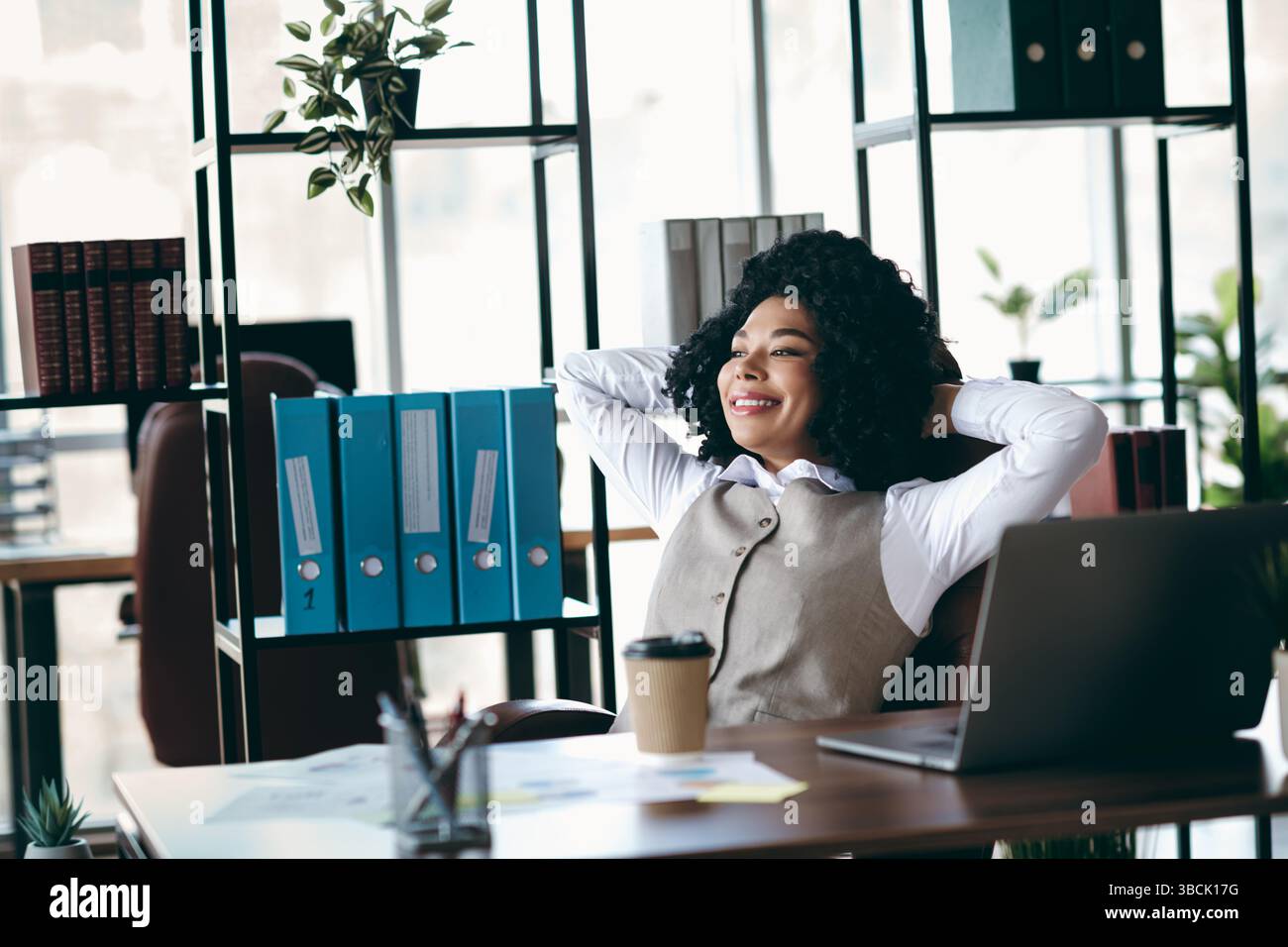 A young professional businesswoman takes a moment to unwind in an ...