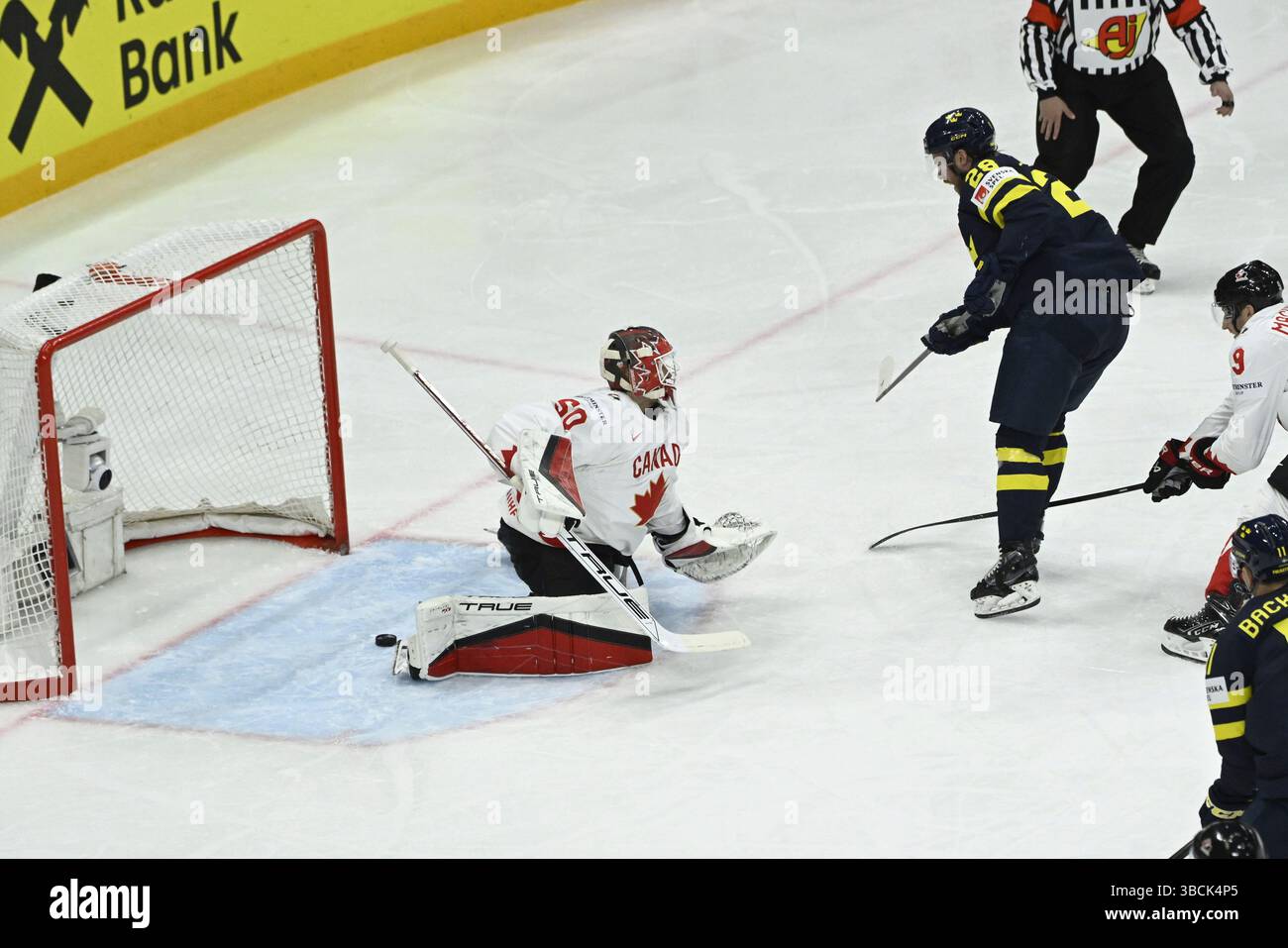 Sweden's Elias Lindholm scores behind Canada's goalkeeper Jordan ...
