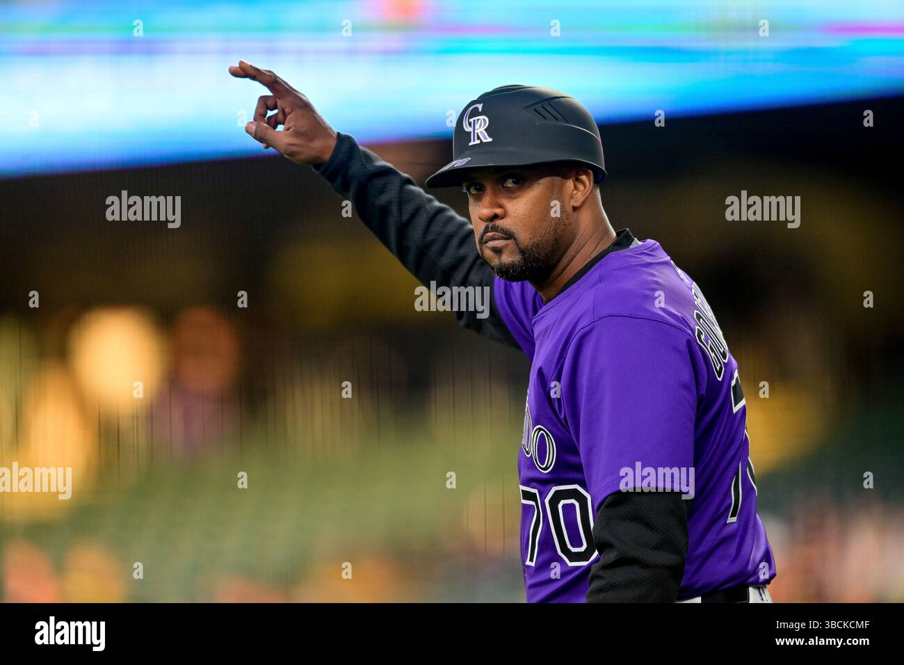 DENVER, CO - MAY 19: Colorado Rockies third base coach Andy González (70) looks on during a game ...
