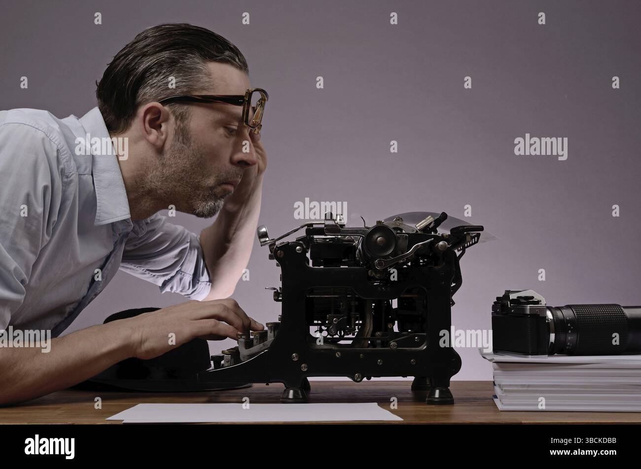 Editor with an old typewriter and retro camera on a wooden office table ...