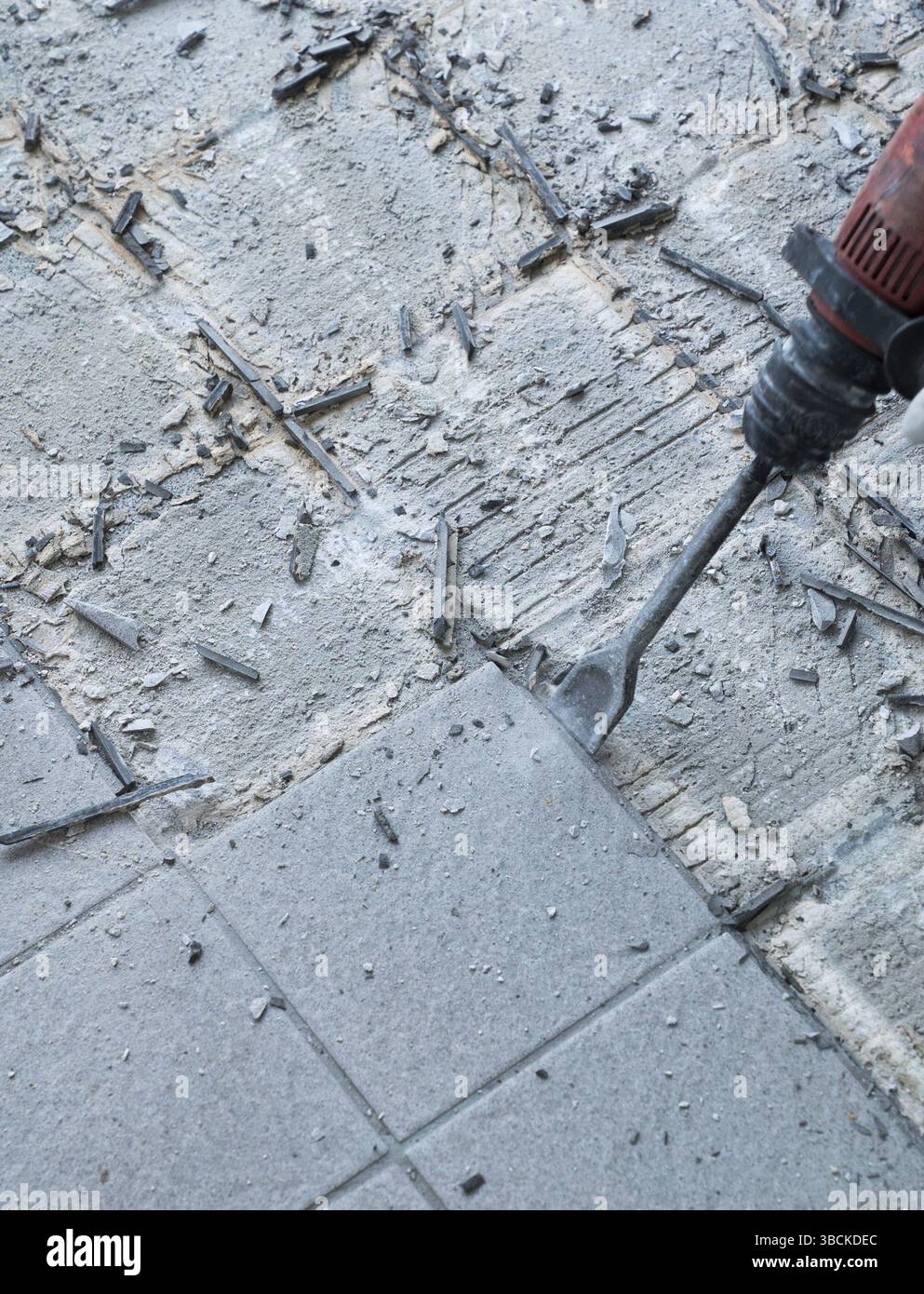 detail view of a construction worker using a handheld demolition hammer ...