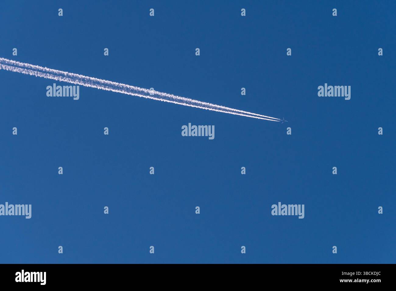 Jet Airplane Flying High through Clear Blue Sky Leaving a Distinct ...