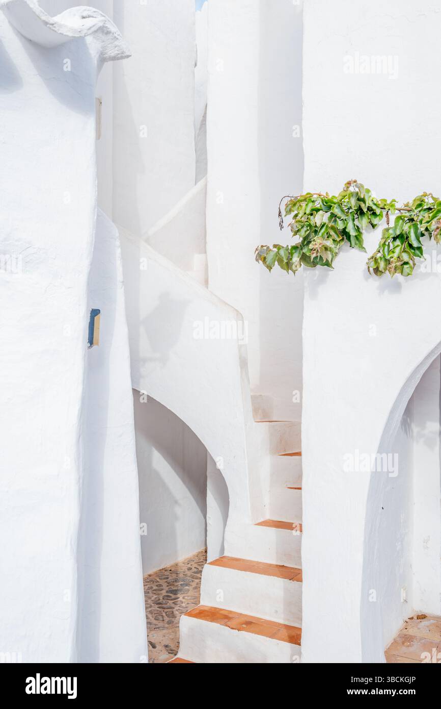 Minimalist Mediterranean architecture with curved white staircase in ...