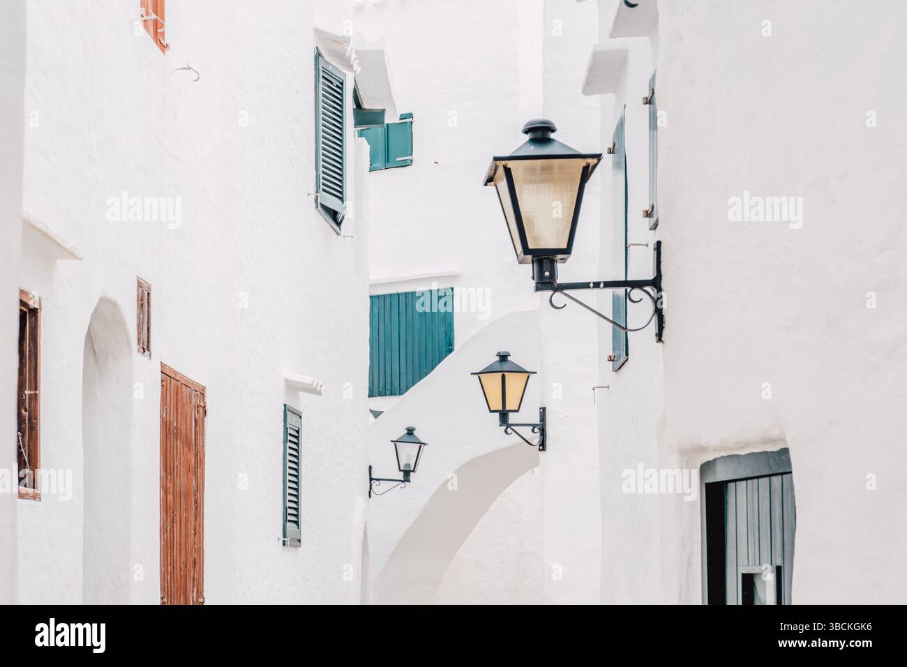 Classic black street lamp on a whitewashed building in a Mediterranean ...
