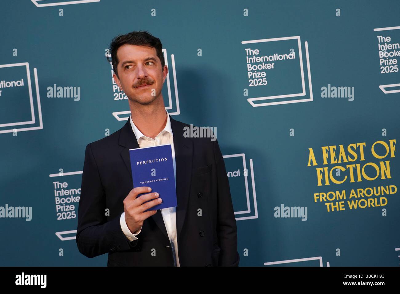 Vincenzo Latronico holds his book 'Perfection' as he poses for ...