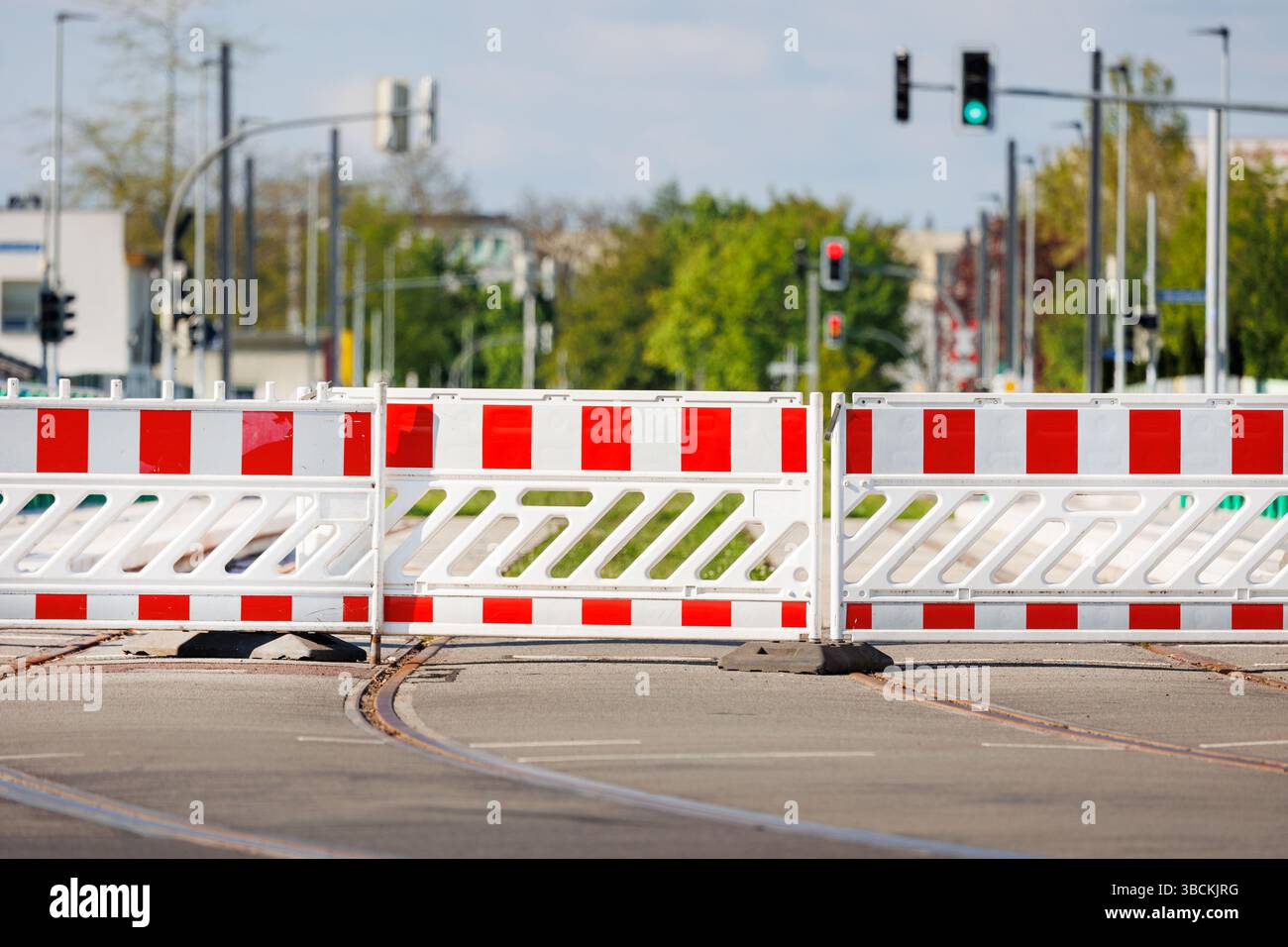 Temporary red-white traffic barricades block access to tram tracks on ...