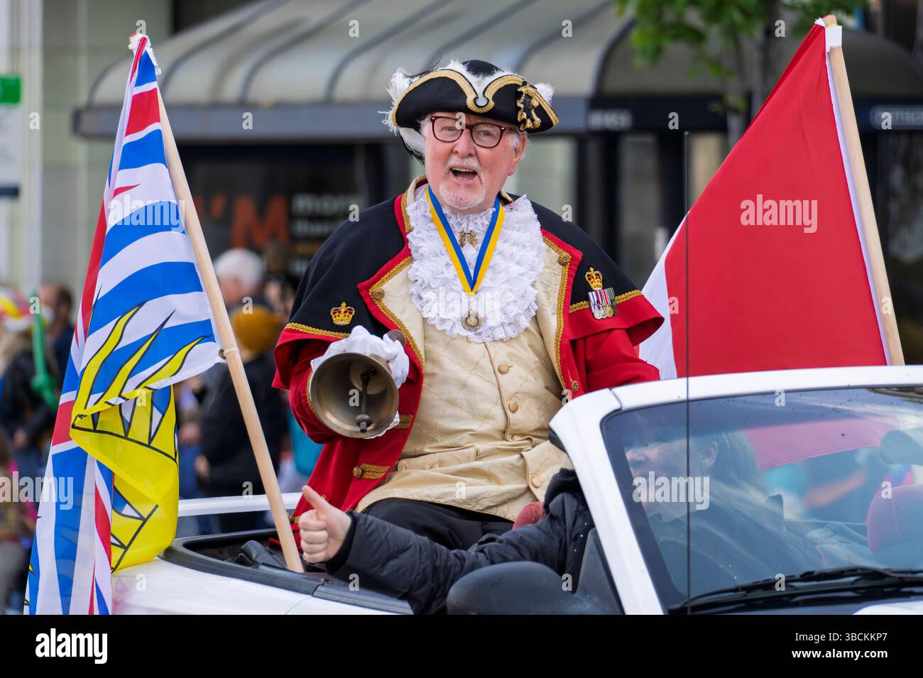A town crier with a bell at the Victoria Day Parade on May 19, 2025 in ...