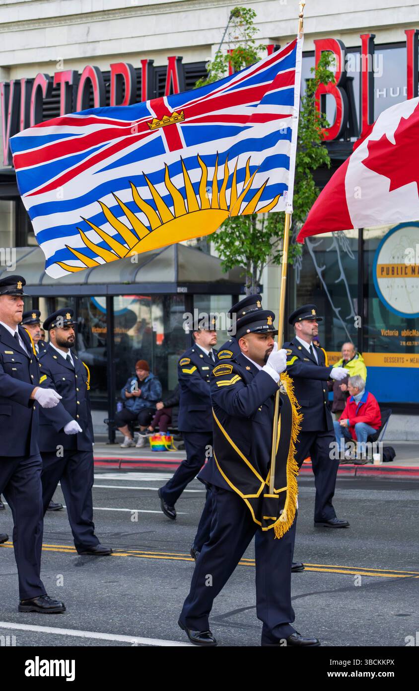 A flag bearer at the Victoria Day Parade on May 19, 2025 in Victoria ...