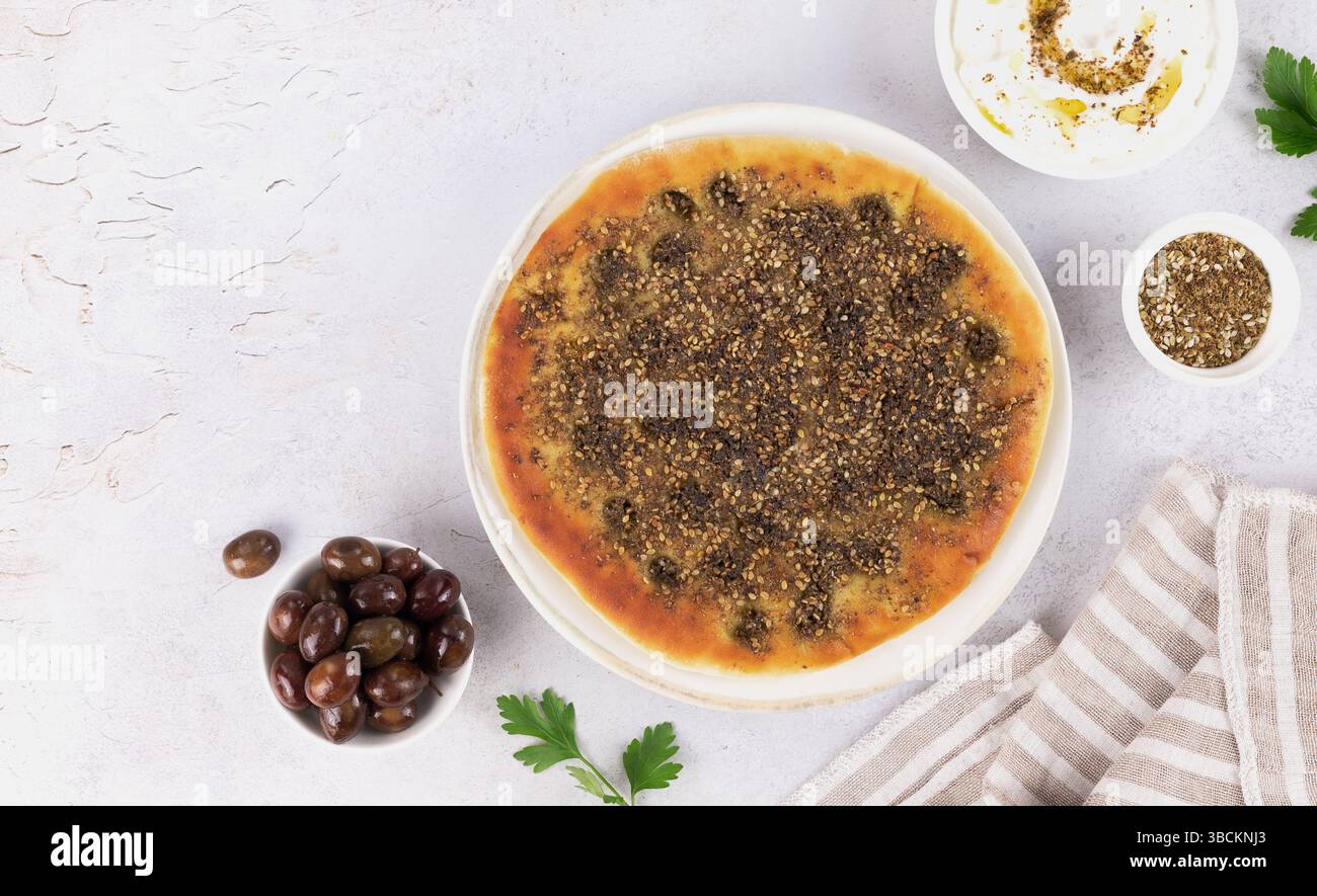 Flatbread Manakish with zaatar, olives, labneh on white background ...