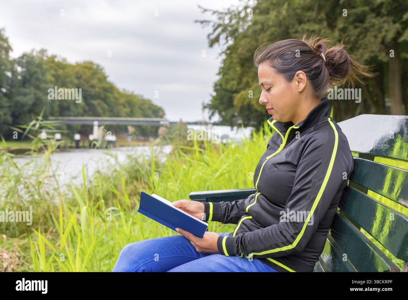 Woman reading book river hi-res stock photography and images - Alamy