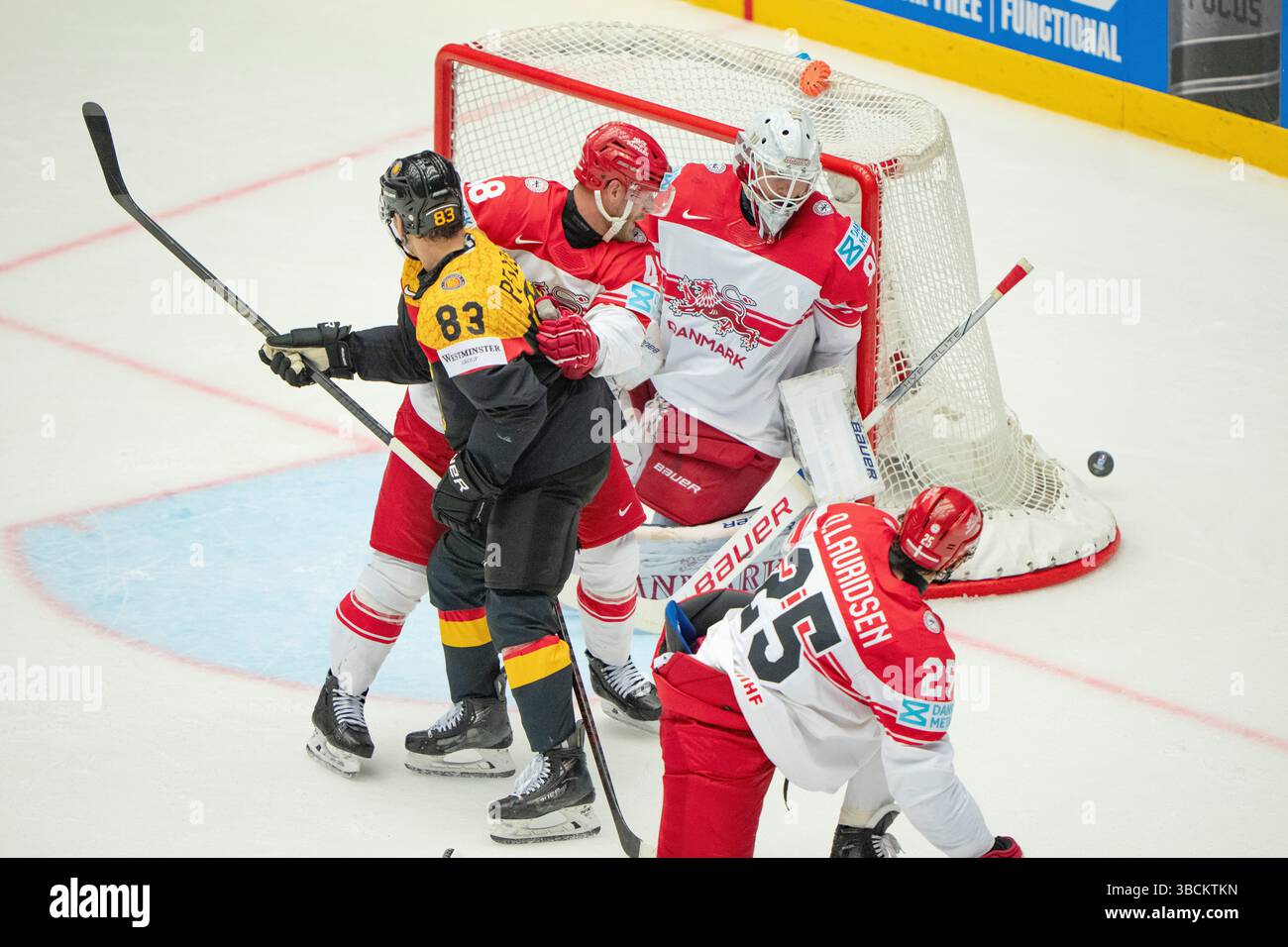 Germany's Leonhard Pföderl, left, in action with Denmark goalkeeper Frederik Dichow, Oliver ...