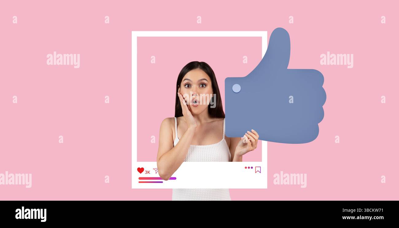 Influencer showing surprise with thumbs up on a pink backdrop Stock ...
