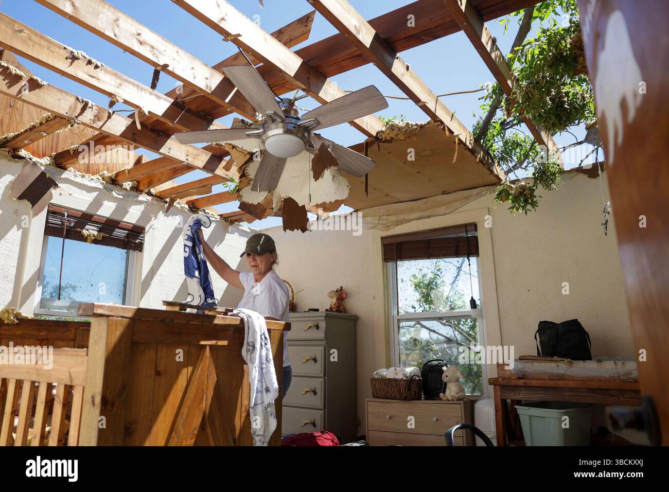 A friend of the Hedgecocks salvages items from the nursery of their home that was damaged by ...