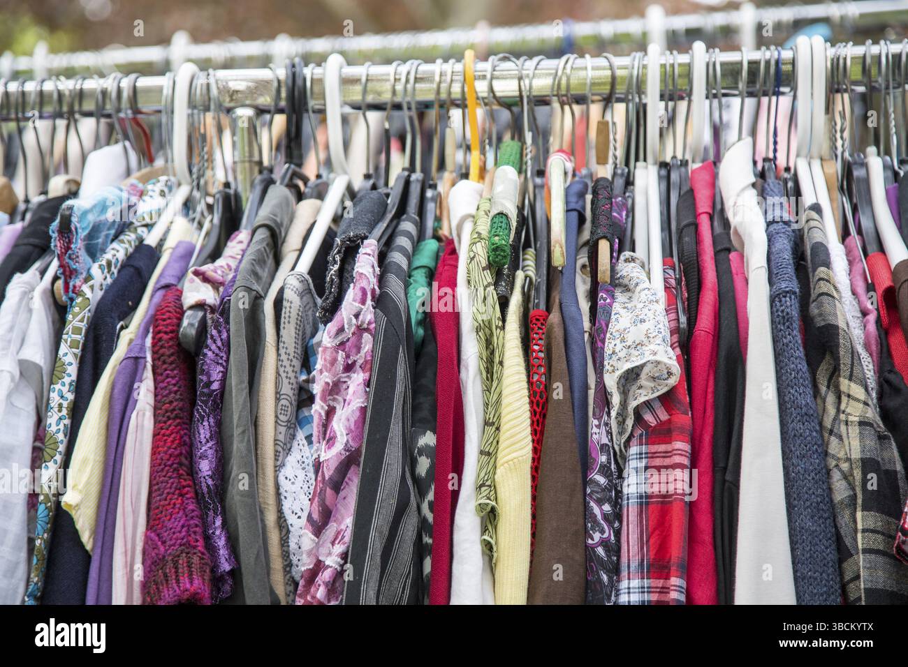 Clothes on a rack in a flea market Stock Photo - Alamy
