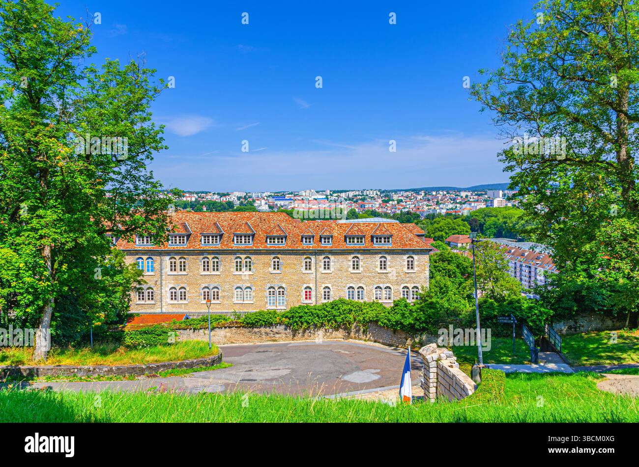 Road, green trees and bushes and Centre des monuments nationaux ...