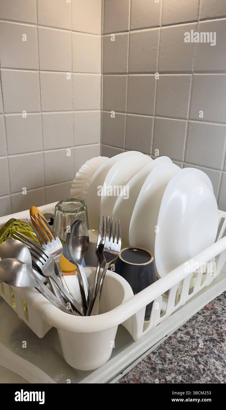 Dish drying rack in modern kitchen showcasing clean utensils and plates ...
