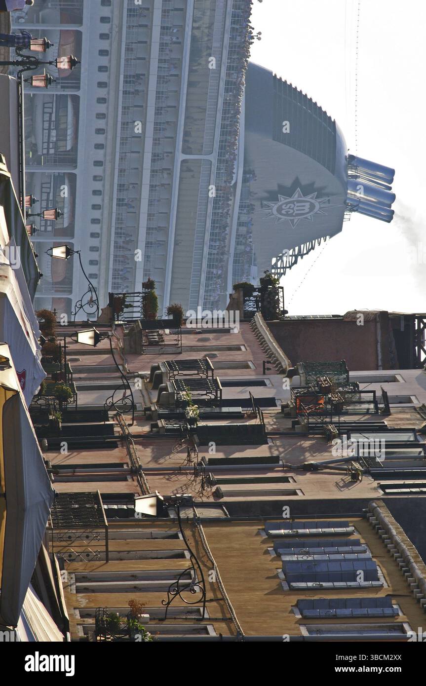 Multi-storey passenger ship approaches the jetty in the centre of ...